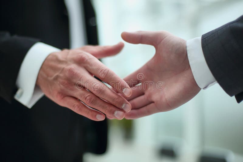 Image of Business People Holding Out Their Hands for a Handshake. Stock ...
