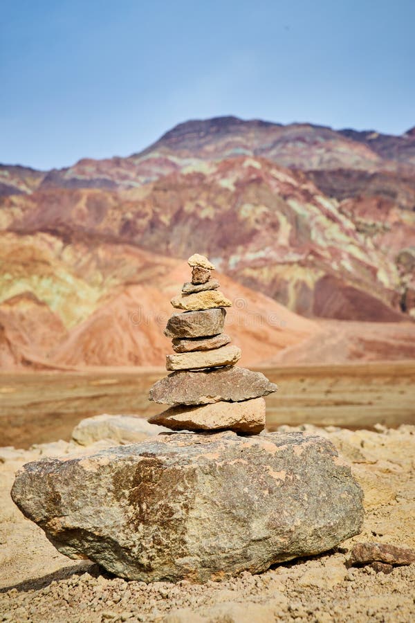 Cairn Rock Stack in Front of Mountain with Colorful Layers Stock Photo ...