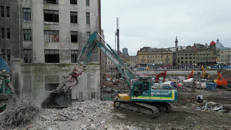 Aerial Drone Shot of a Digger Demolishing a Large Building in the ...