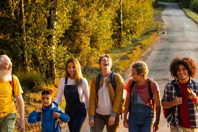 Multi-Generational Friends Enjoying a Walk on a Sunny Path Stock Photo ...