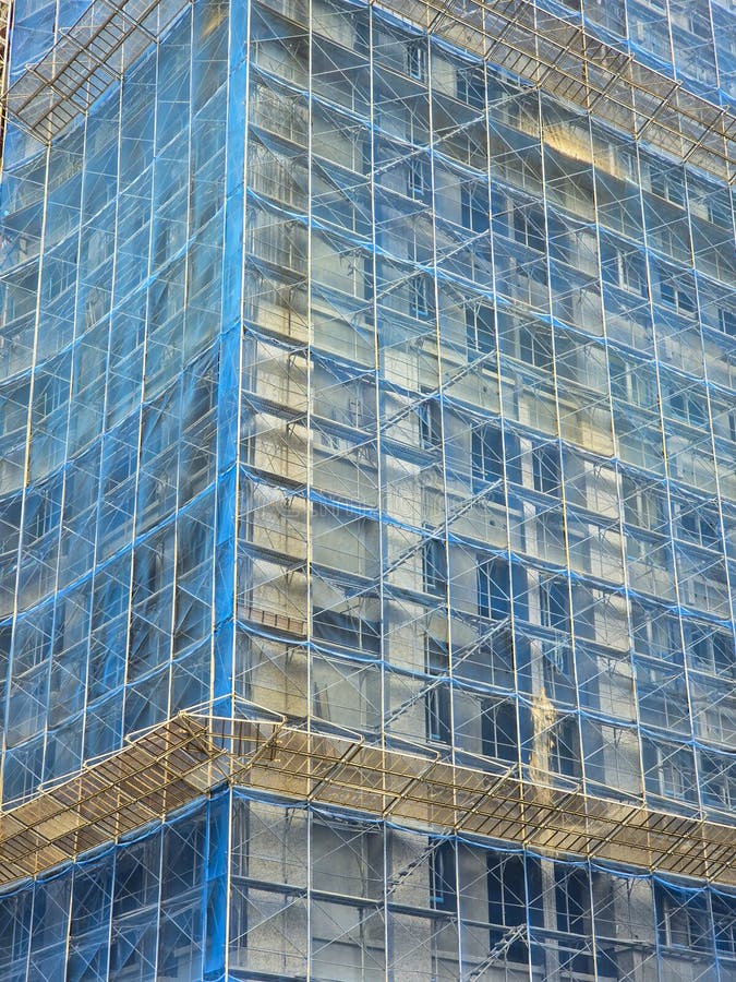 Construction in Progress: Building with Scaffolding and Blue Drapes ...
