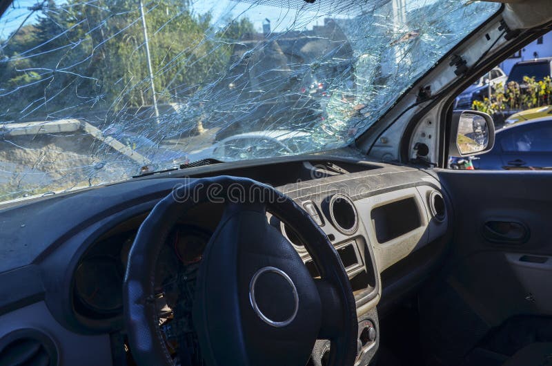 This Image Captures the Interior of a Car with a Severely Cracked ...