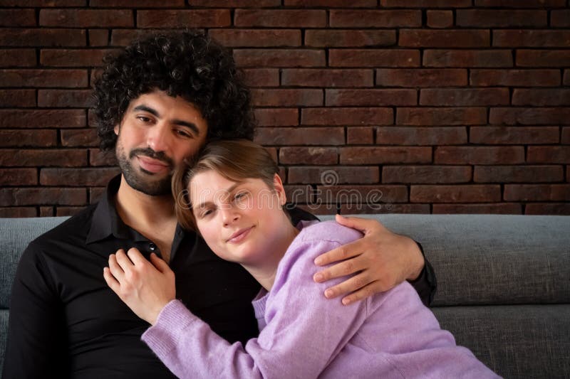 Cozy Embrace on a Couch stock image. Image of affectionate - 310743119