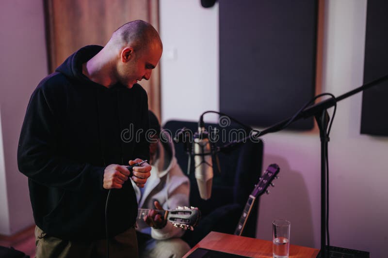 The Image Captures a Musician and a Producer Working Together in a ...