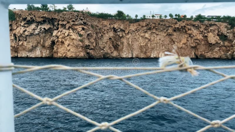 View of a Rugged Cliff from the Perspective of a Boats Deck at Sea ...