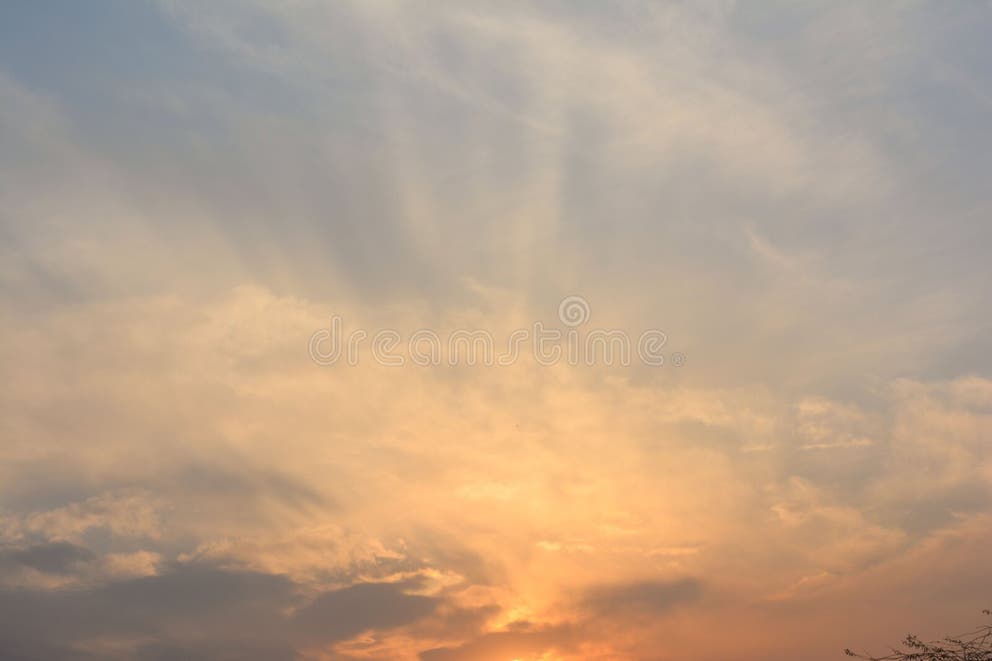 The Image Captures a Sunset Scene with the Sun Setting Behind a Layer ...