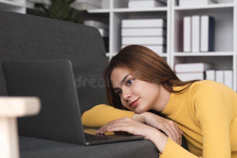 Image of Cheerful Asian Woman in Laying on Sofa Using Laptop. Stock Photo - Image of smile ...