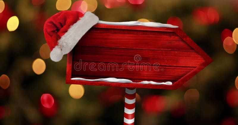 Image of Christmas Arrow with Santa Hat Over Blurred Lights Stock Image ...