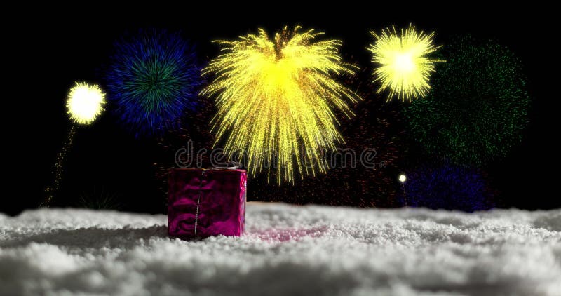 Image of Christmas Present in Snow and Yellow Fireworks Exploding in ...