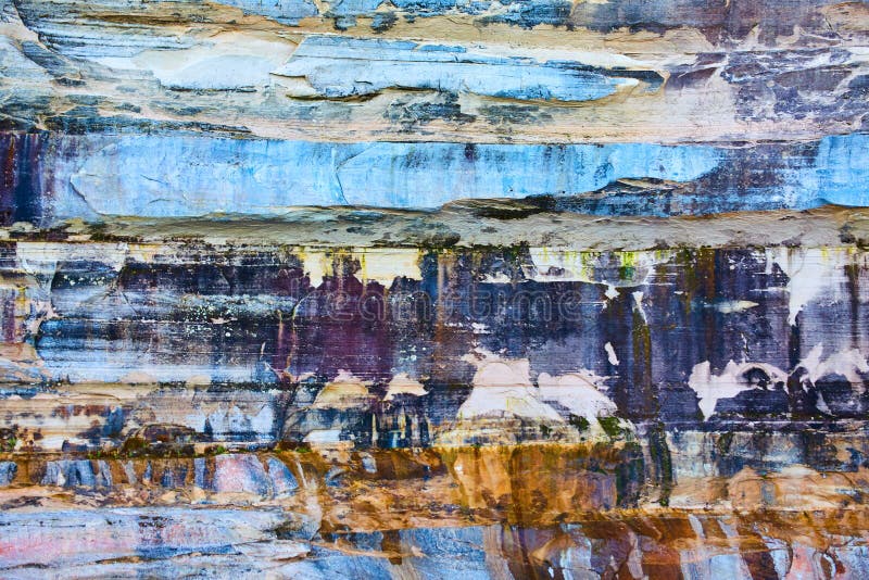 Cliff Wall Background with Blue, Black, and Rust Colored Stone at ...