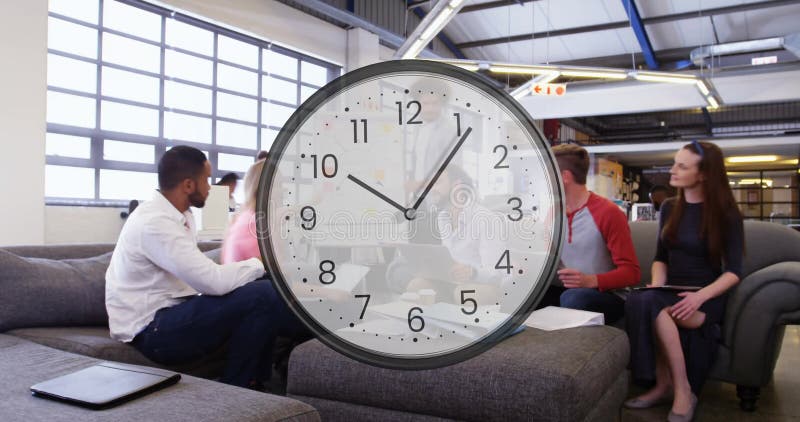 Image of Clock Ticking Over Diverse Business People in Office Stock ...