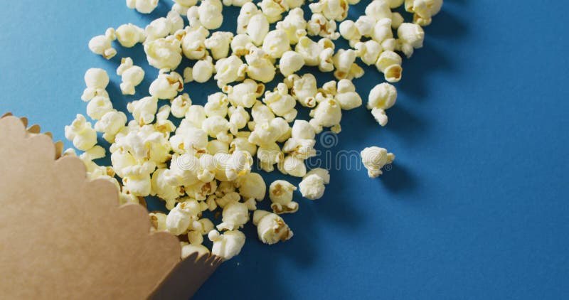Image of Close Up of Box of Popcorn on Blue Background Stock Photo ...