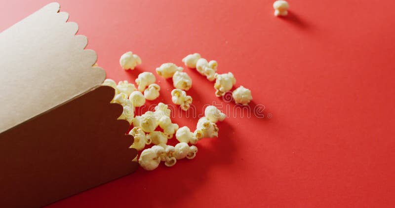 Image of Close Up of Box of Popcorn on Red Background Stock Image ...