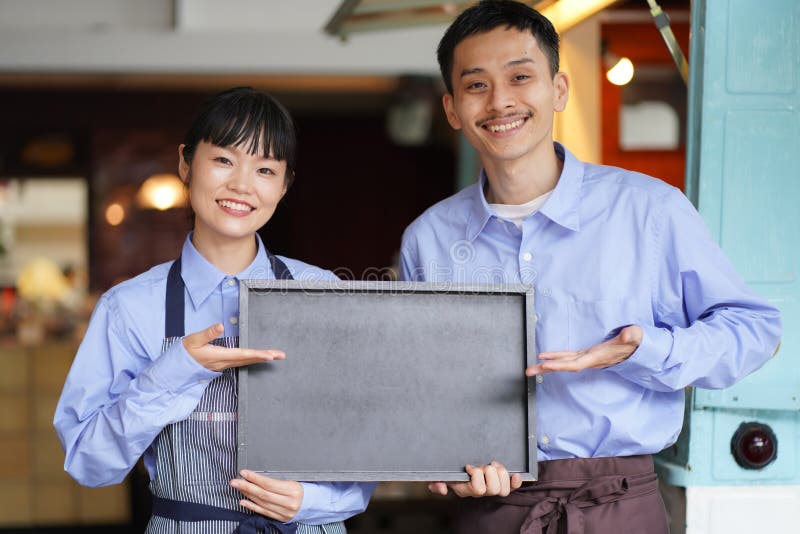 A Couple Holding a Message Board in Front of a Kitchen Car Stock Photo ...