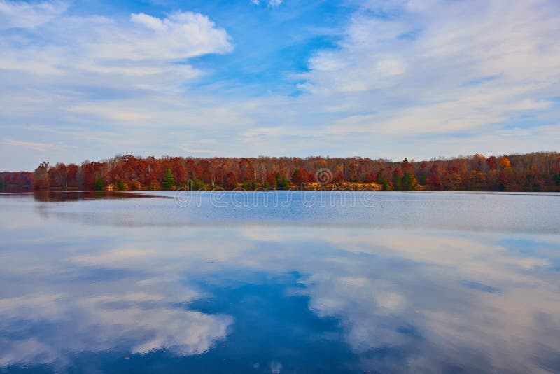 Crystal Clear Lake Surface with Fall Forests Lining the Coast in ...