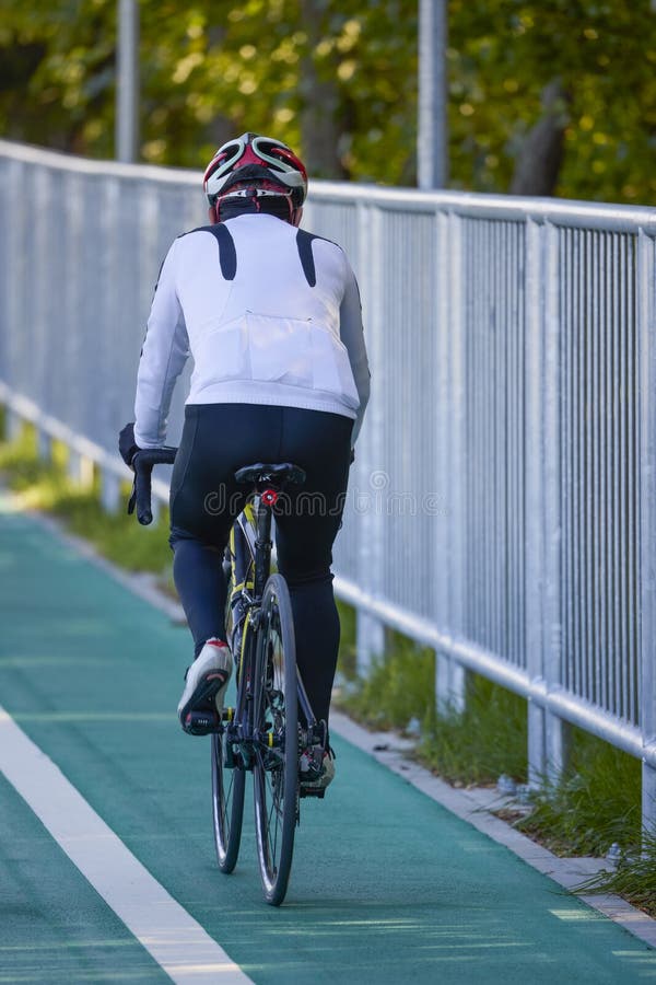 A Cyclist Seen from Behind on a Bike Path Stock Photo - Image of spring ...