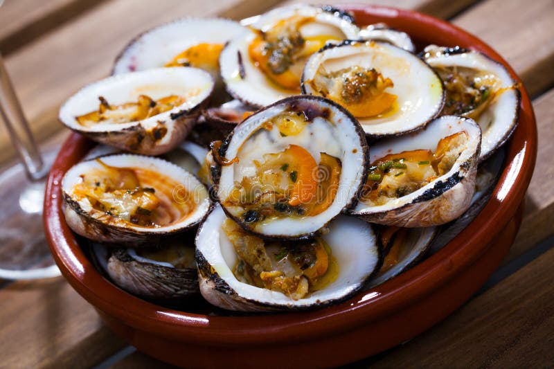 Deliciously Seafood with Baked in Oven Open Seashell at Plate on Table ...
