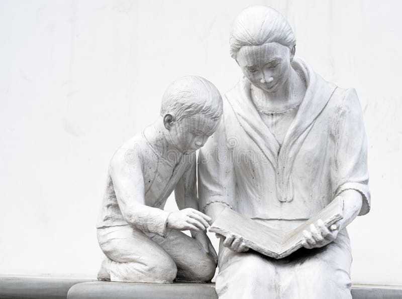 Two Statues Sitting Side-by-side on a Bench, with One of the Figures ...