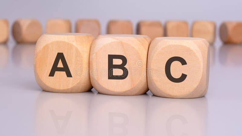 The Image Depicts Three Wooden Blocks with the Letters ABC in Focus ...