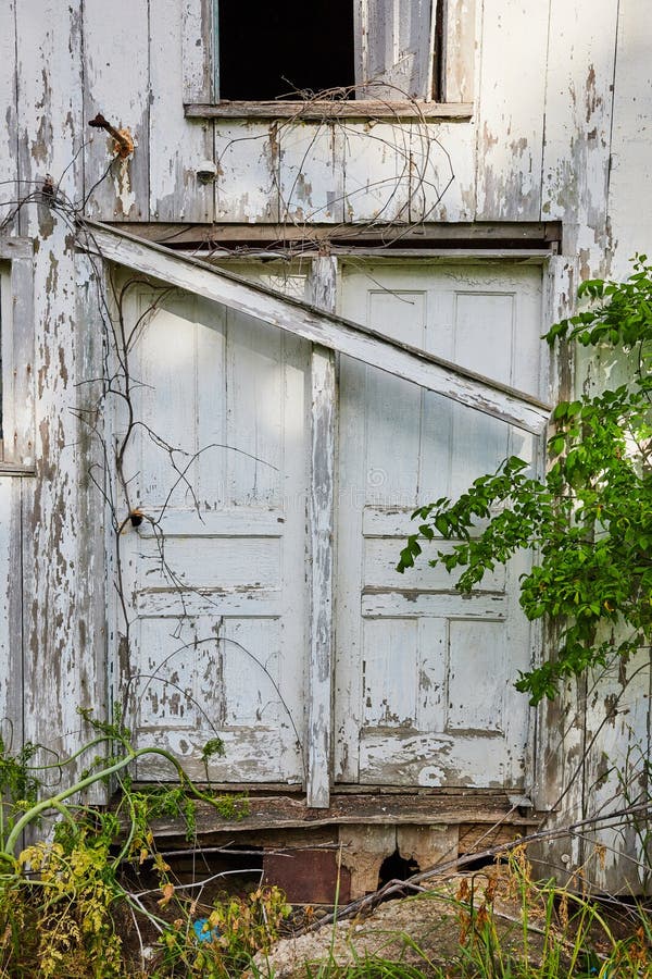Double Doors on Front of Abandoned Country House with White Chipped ...