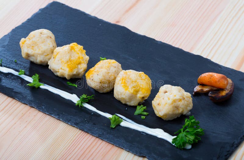 Dumplings of Different White Fish Served with Carrot at Plate on Table ...