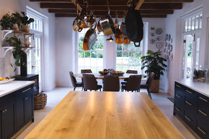 Image of Empty Kitchen with Pots Hanging Over Table Stock Photo - Image ...