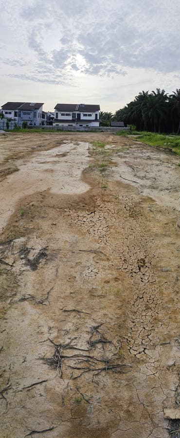 An Empty Plot of Land Scene Besides a Residential Row of Houses. Stock ...