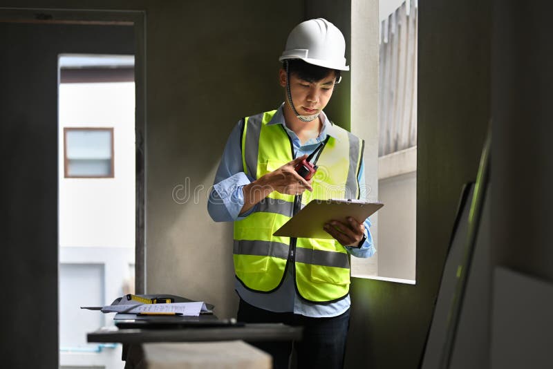 Image of Engineer Man Looking at Clipping Board and Checking Building ...