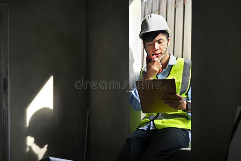 Image of Engineer Man Looking at Clipping Board and Checking Building ...