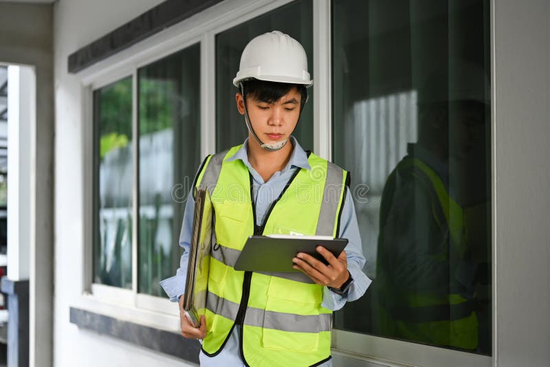 Image of Engineer Man Looking at Clipping Board and Checking Building ...