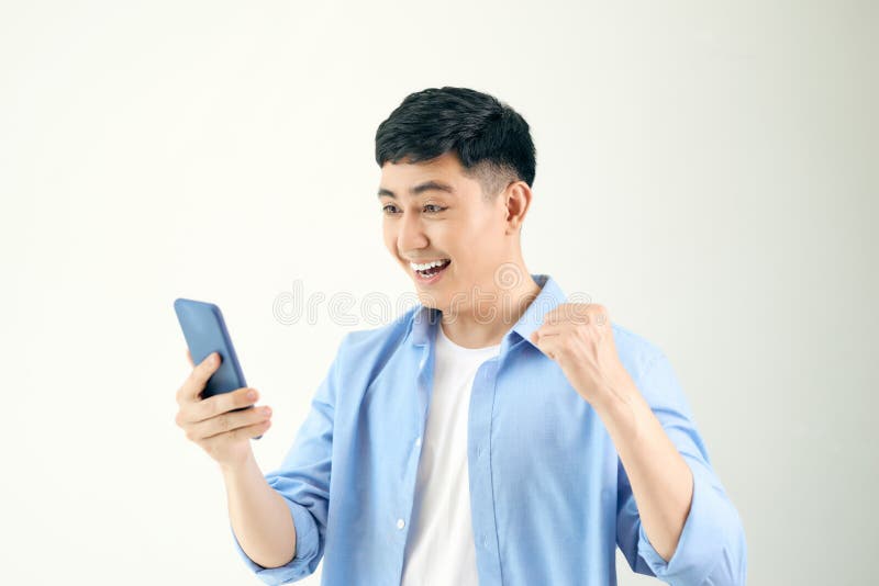 Image of Excited Happy Young Man Posing Isolated Using Mobile Phone ...