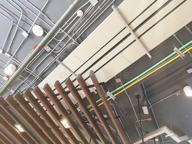 Image of Exposed Mechanical System Installation Above Wooden Striped ...