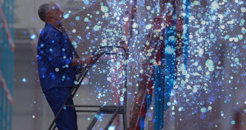 Image of Falling Glowing Dots Over Caucasian Male Warehouse Worker ...