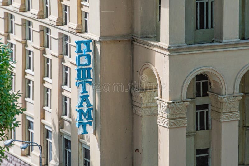 The Image Features a Beige Stone Building with Classical Elements ...