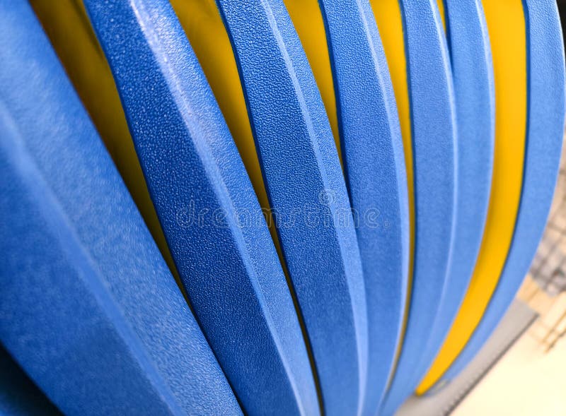 This Image Features a Closeup View of a Blue and Yellow Striped Plastic ...