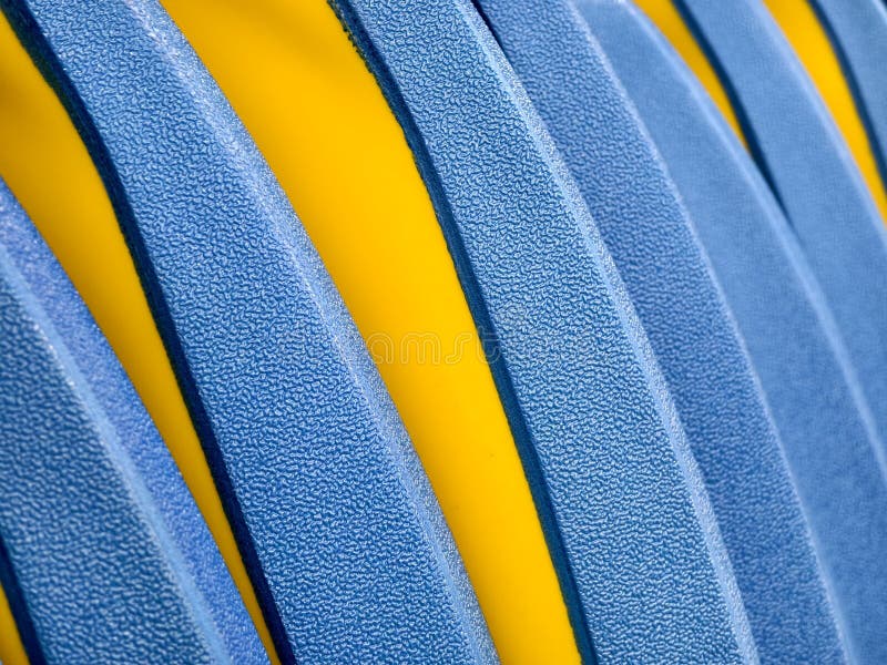 This Image Features a Closeup View of a Blue and Yellow Striped Plastic ...