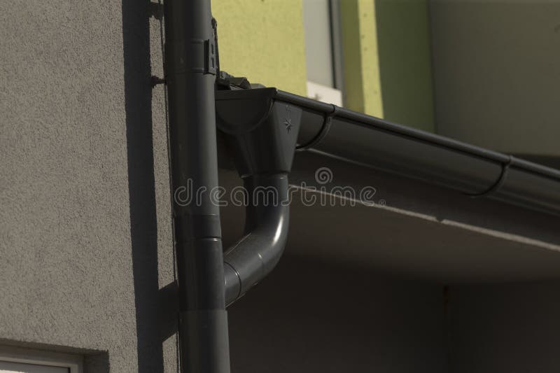This Image Features a Detailed Close Up of a Gutter on the Side of a ...