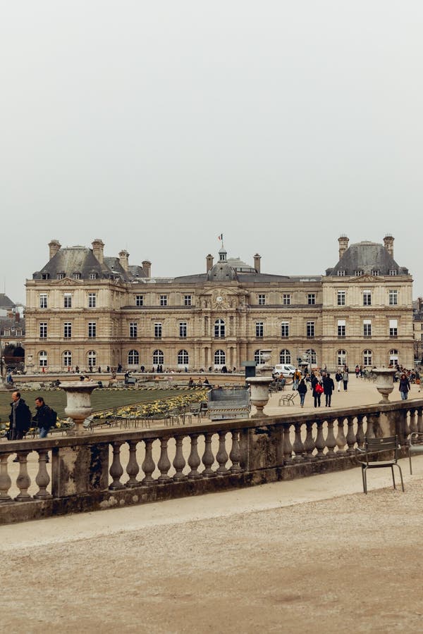 There are People Sitting on this Fence in Front of an Old Mansion ...