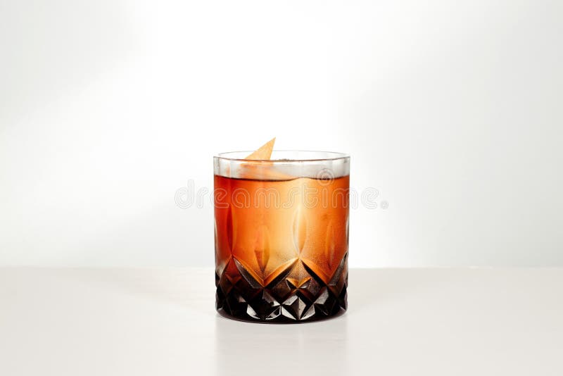 Image Features a Refreshing Cocktail with a Decorative Orange Garnish ...