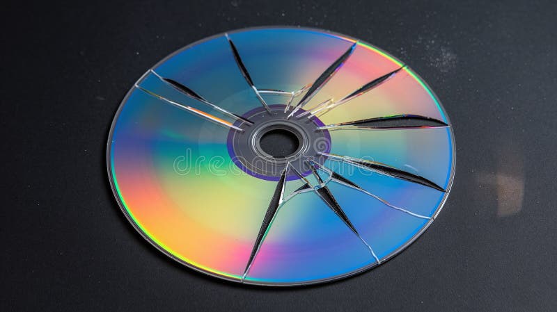 Shattered Compact Disc with Rainbow Reflections on Dark Black Surface ...