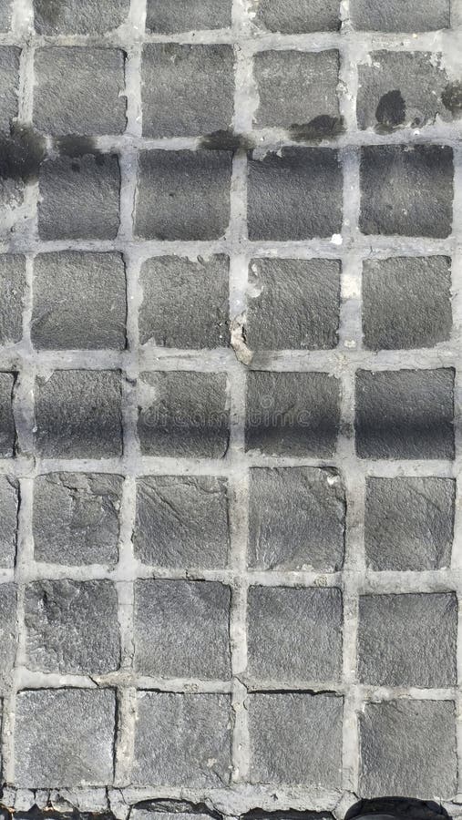 Image Features Textured Gray Cobblestone Pavement with Grid Pattern ...
