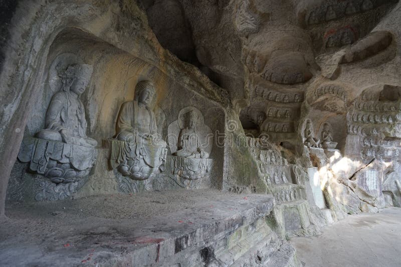 An Underground Caves with Carvings on the Side of it and a Ceiling ...