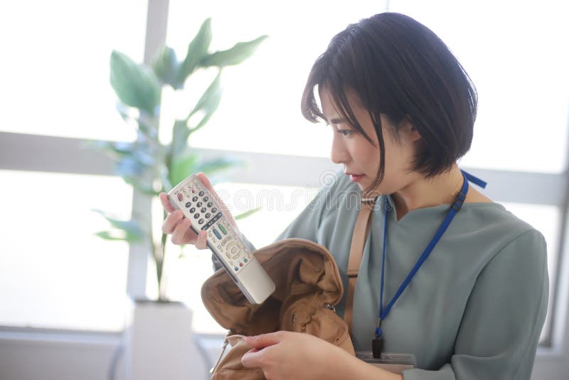 A Female Employee Whose Remote Control Came Out of the Bag Stock Photo ...