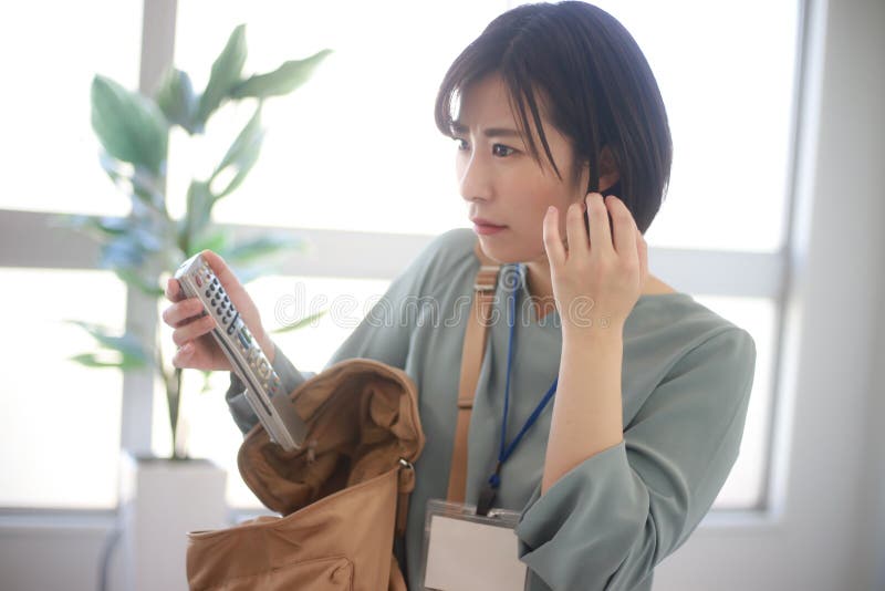 A Female Employee Whose Remote Control Came Out of the Bag Stock Photo ...