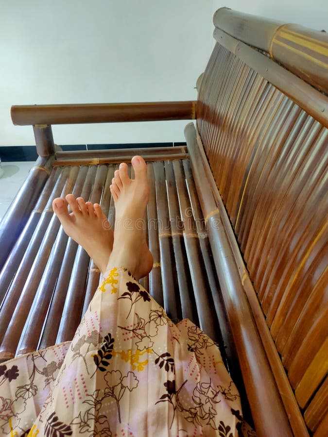 Female Feet Relaxing on Bamboo Bench Stock Photo - Image of dressed ...