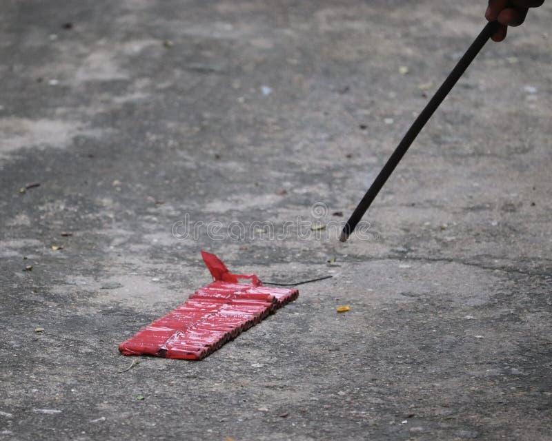 Image of Firing a 100 Wala Using Lengthy Firing Stick Stock Photo ...