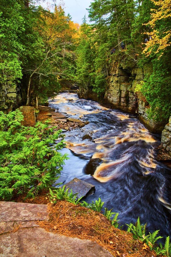 Flowing River with a Few Rapids As it Passes through a Gorge with Rock ...