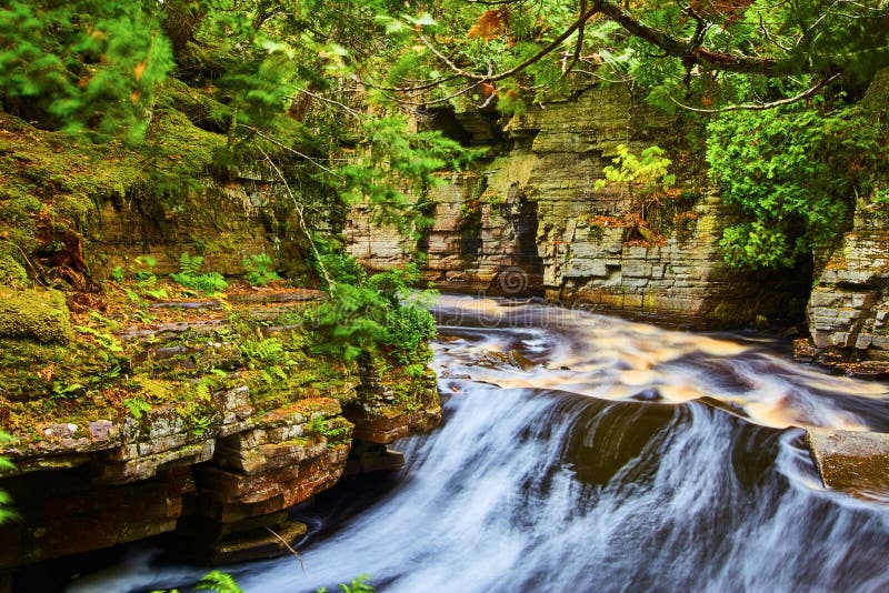 Flowing River with Swirling Pools of Water and Cliffs Stacked Like ...