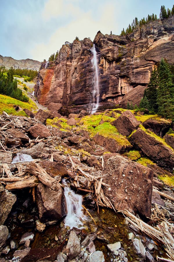 Gigantic Waterfall Over Vertical Cliffs Leading To Boulders of Moss in ...