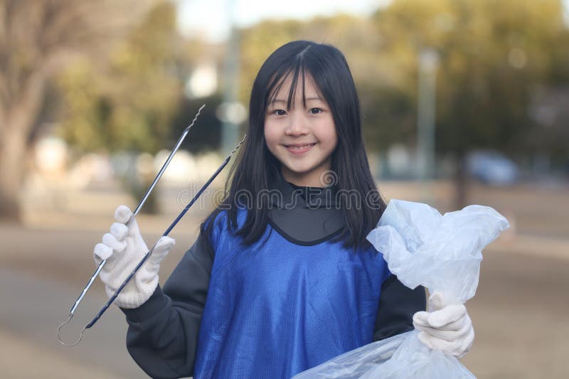Girl picking up trash stock photo. Image of copy, japan - 343351006